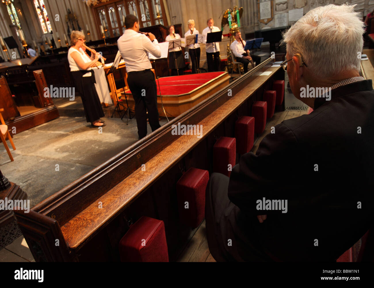 A Priest watches the group of Musicians playing Recorders in Bath ...