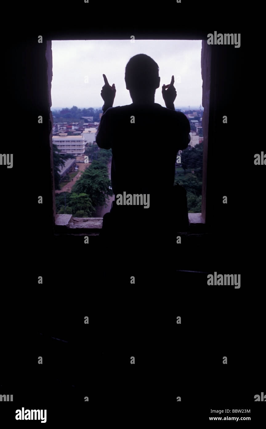 Silhouette of a man praying at a window with his hands raised Stock ...