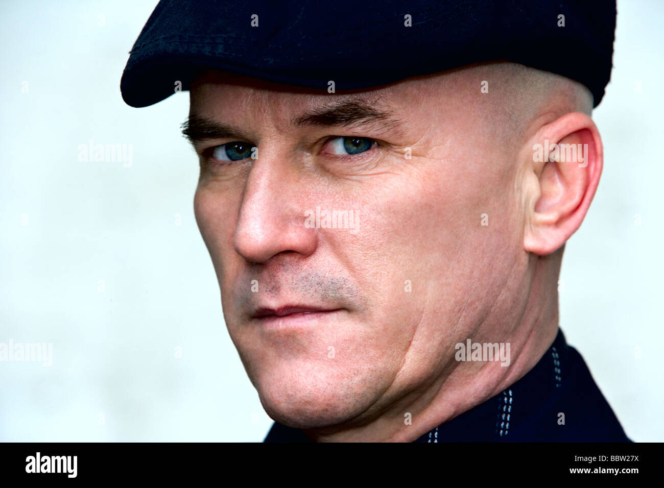 Bald man in his late 40's wearing a dark suit and cap Stock Photo - Alamy