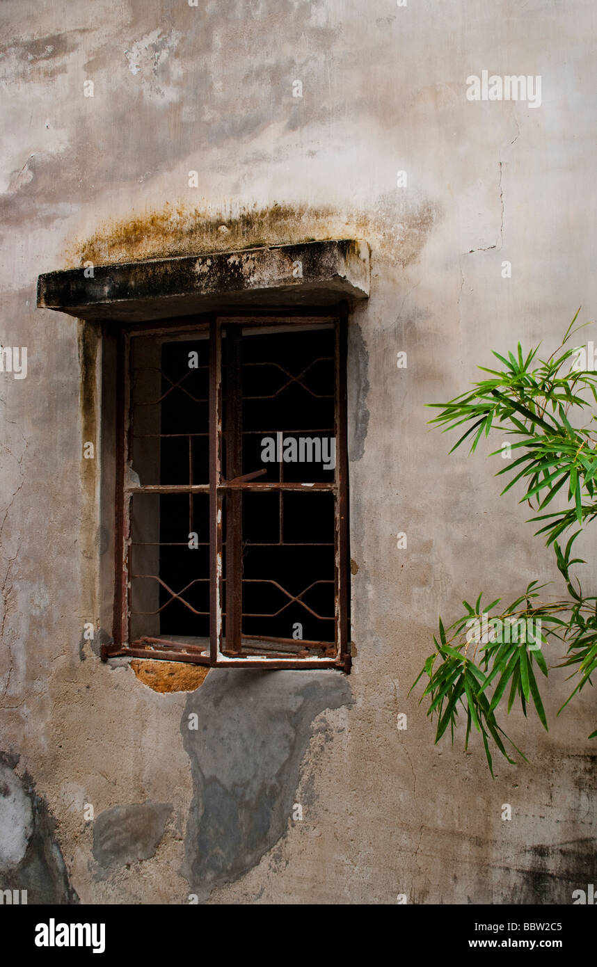An ancient window in Dapeng Fortress stares into space on a barren wall ...