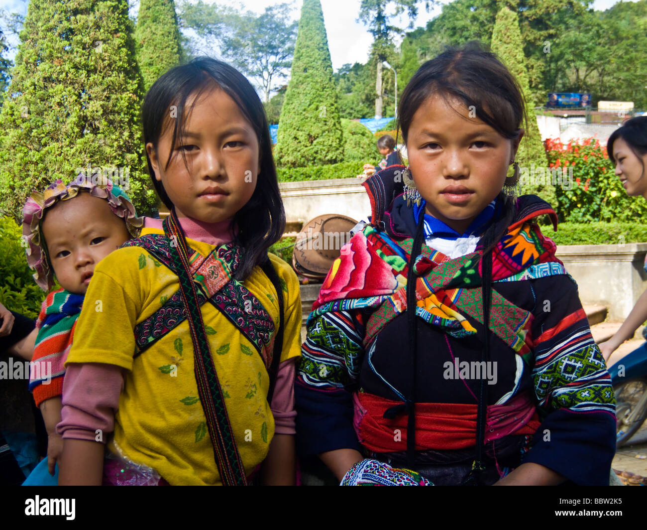 Two young Hmong girls with one carrying baby on her back, Sapa, Vietnam ...