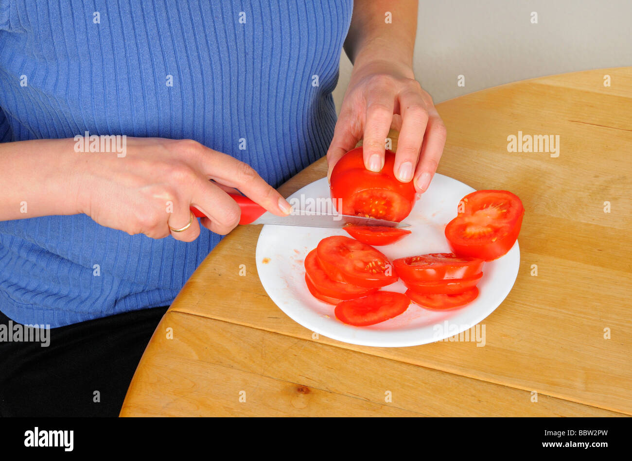 Cutting a tomato Stock Photo - Alamy