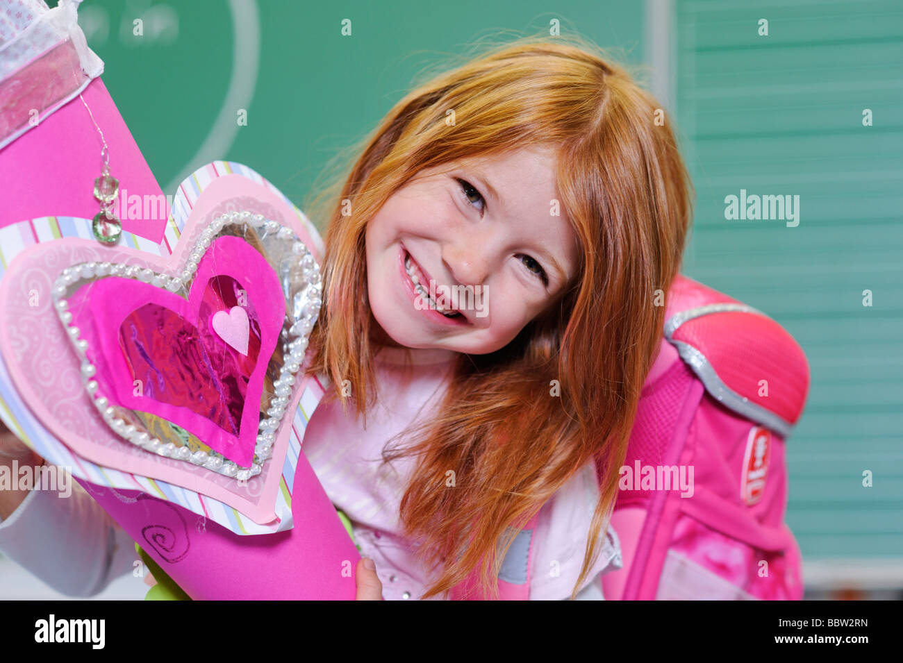 Girl on her first day at school holding a schultuete, school cone ...