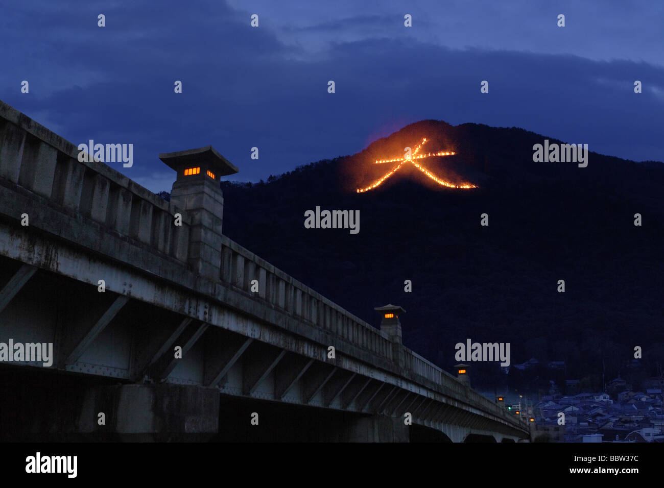 Japanese sign on hilltop with illuminated lights on bridge Stock Photo ...