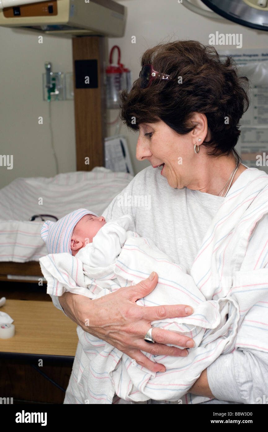 Grandmother holds her newborn grandson at the hospital on the day he ...