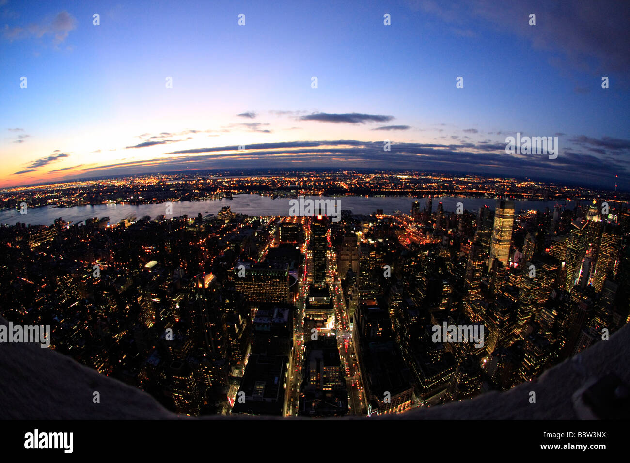 A night time view of building tops in New York City, from midtown area ...
