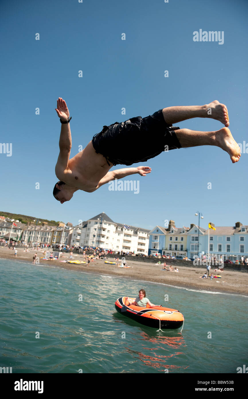 A teenage man diving into the sea flying through the air Aberystwyth ...
