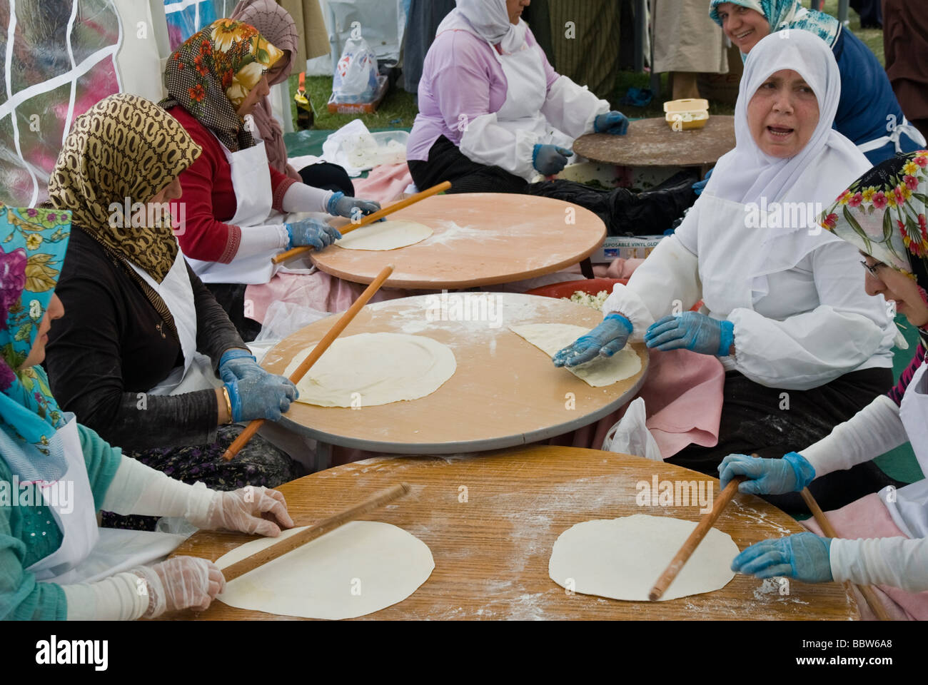 COUPLE OF TURKISH ELDERLY WOMAN MAKING PASTRY DURING THE TURKISH ...
