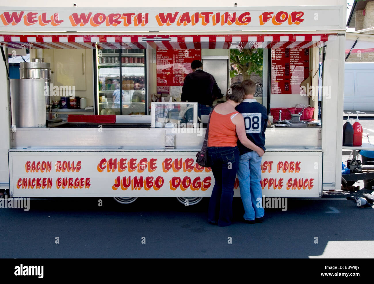 A couple wait to be served at a Fast food stall: Frome Saturday market ...