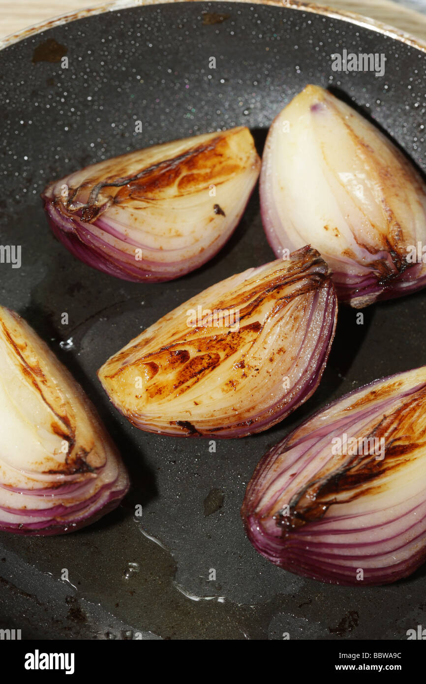 Close Up Of Fresh Ripe Red Onions In A Frying Pan Being Cooking And ...