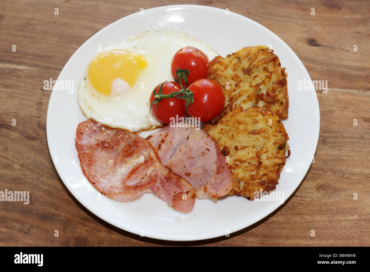 Traditional British Full English Cooked Breakfast With A Fried Egg Tomatoes Bacon And Hash ...