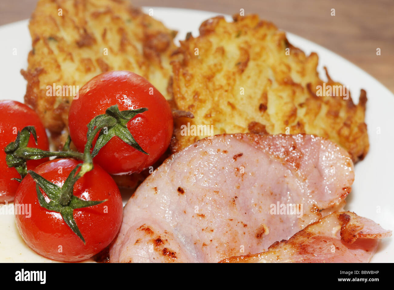 Traditional British Full English Cooked Breakfast With A Fried Egg Tomatoes Bacon And Hash ...