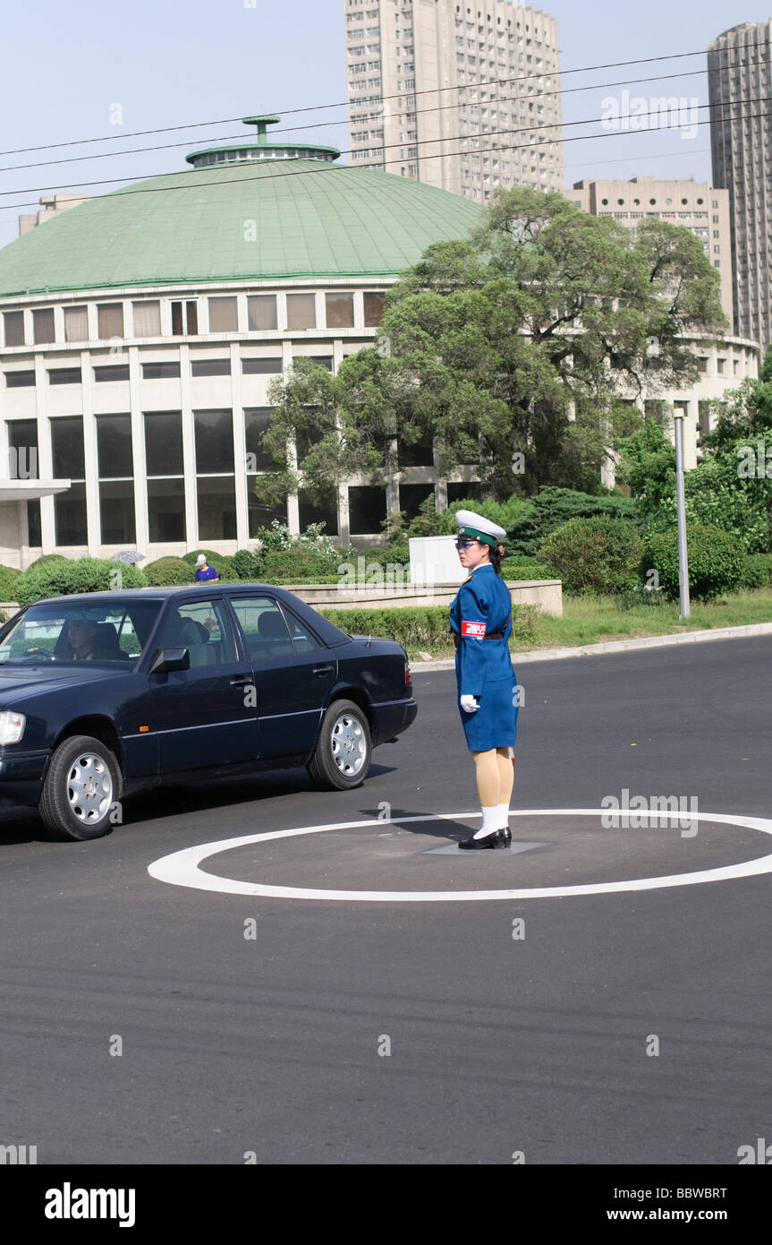 Traffic girl or traffic cop directing traffic in downtown Pyongyang ...