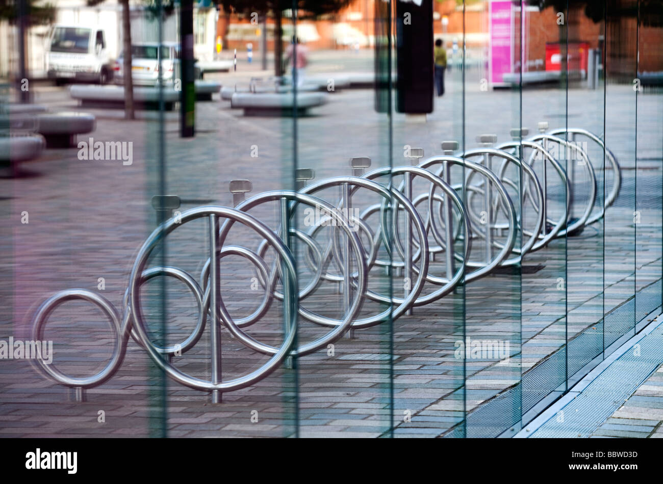 A row of bicycle racks reflected in the windows of The Public building ...