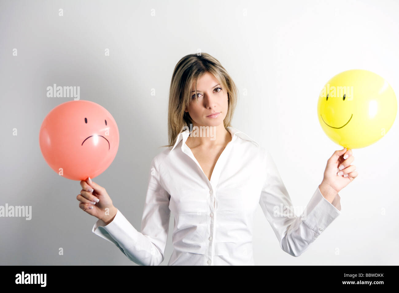 woman holding two balloons with face Stock Photo - Alamy