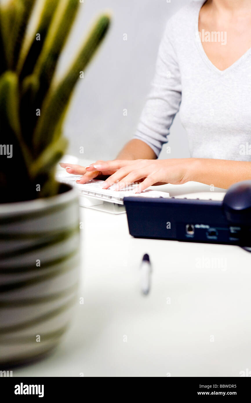 woman to typing in keyboard in office Stock Photo - Alamy