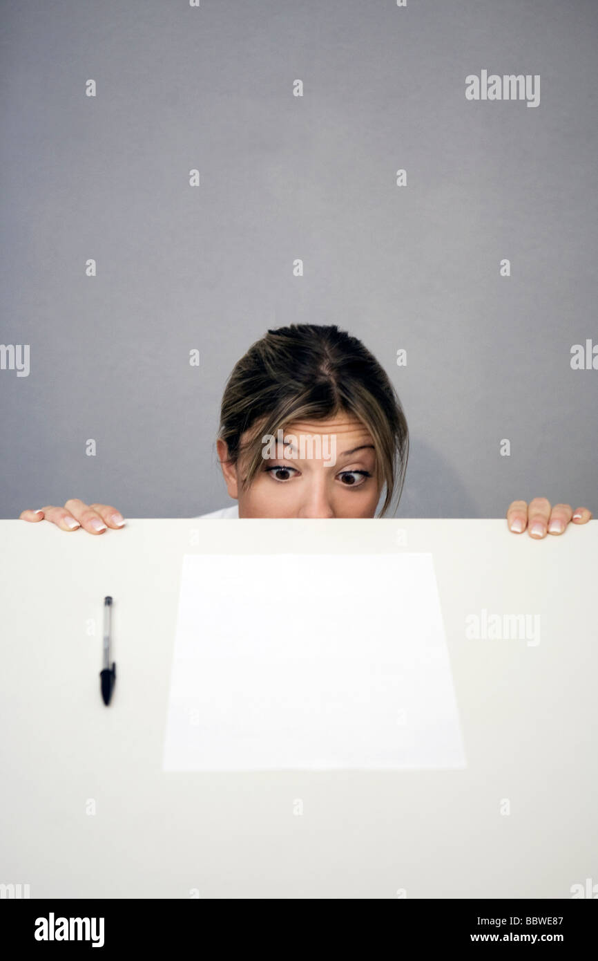 frightened young woman and sheet of paper Stock Photo - Alamy