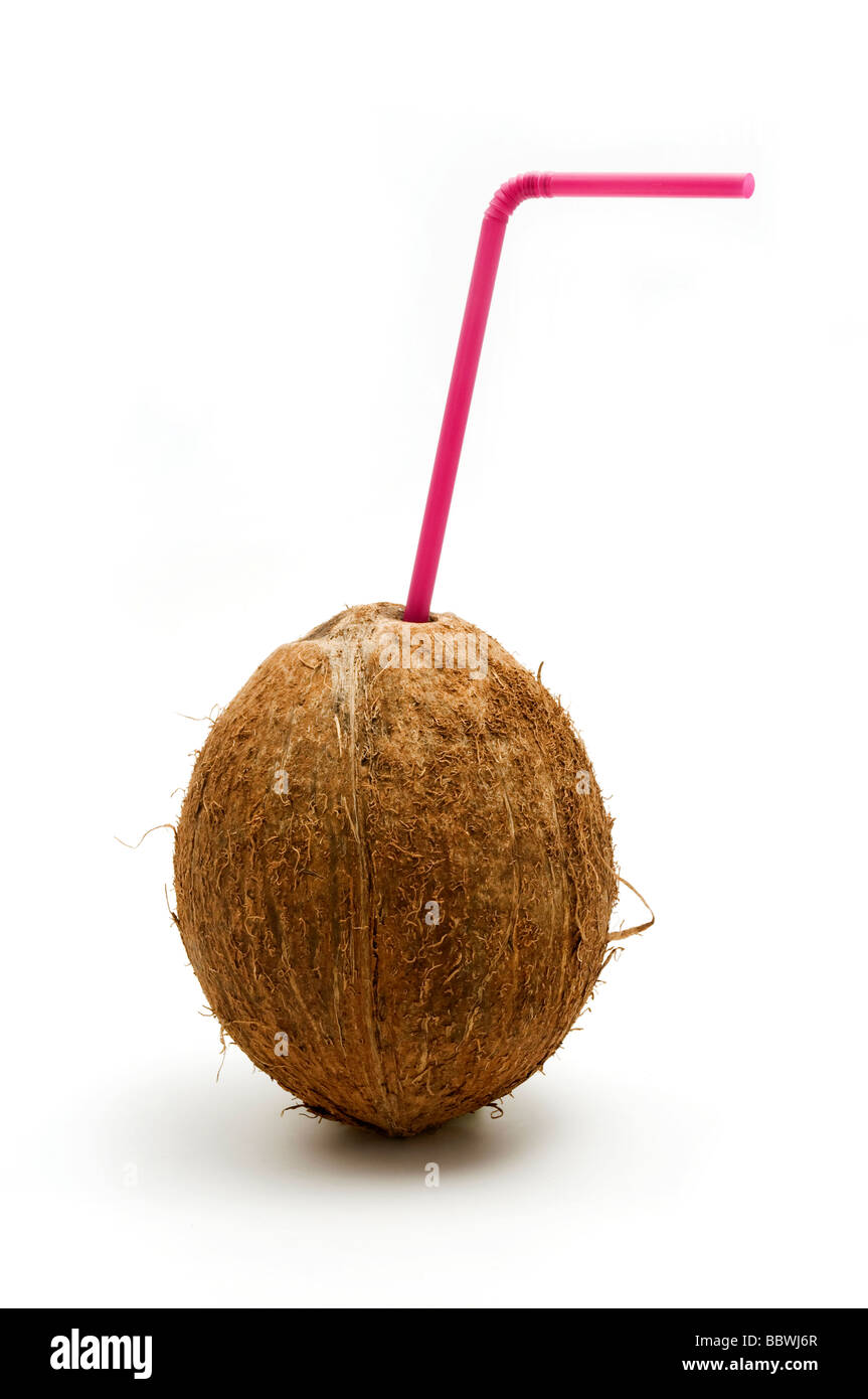 Coconut with a purple straw on a white background Stock Photo - Alamy