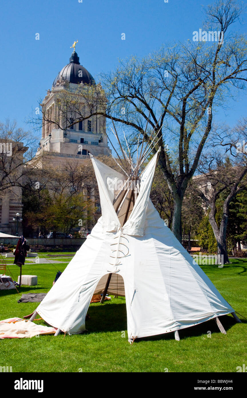 An aboriginal teepee with the dome of the Manitoba Legislative ...