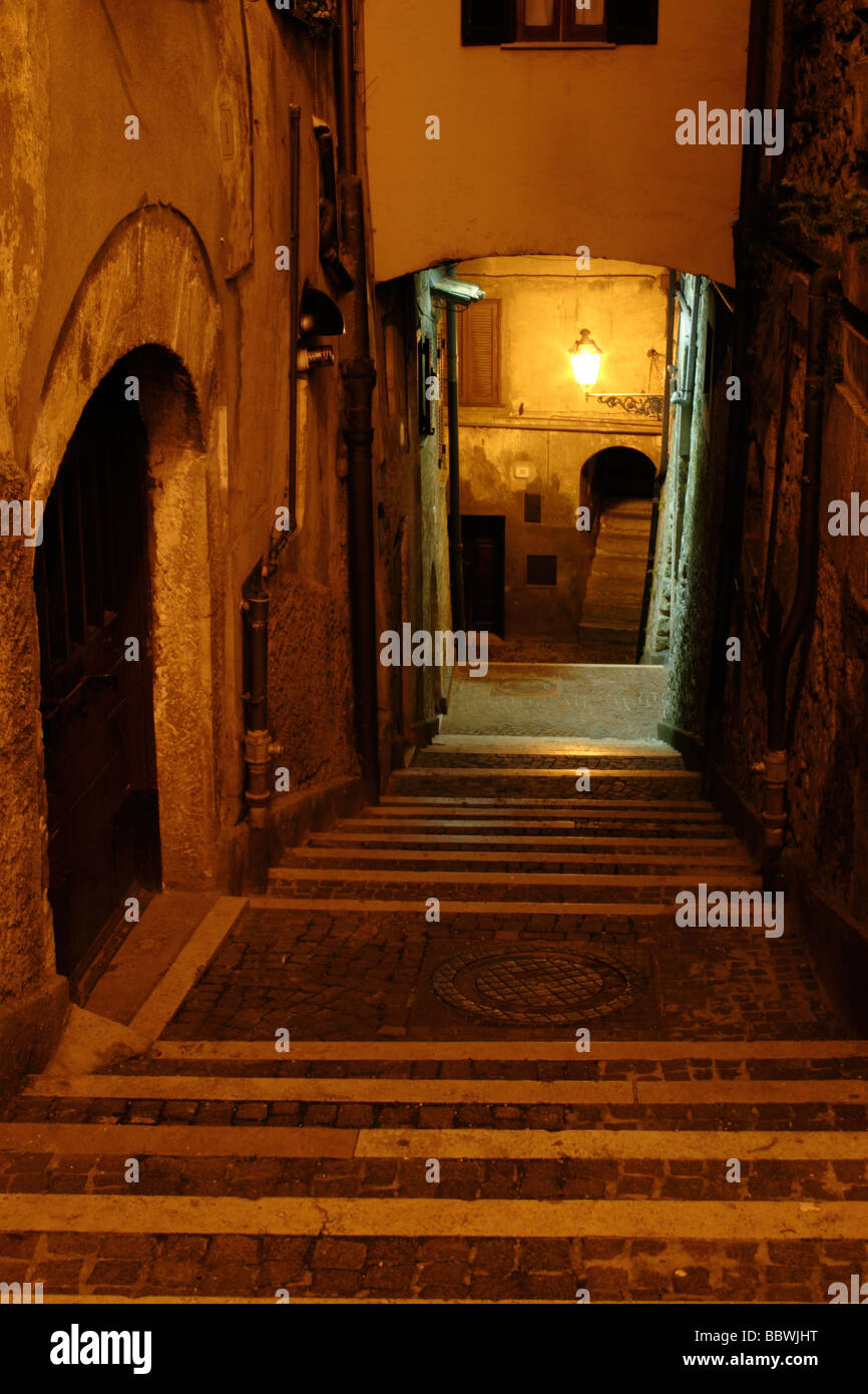 Steps leading down a steep passageway at night Stock Photo - Alamy