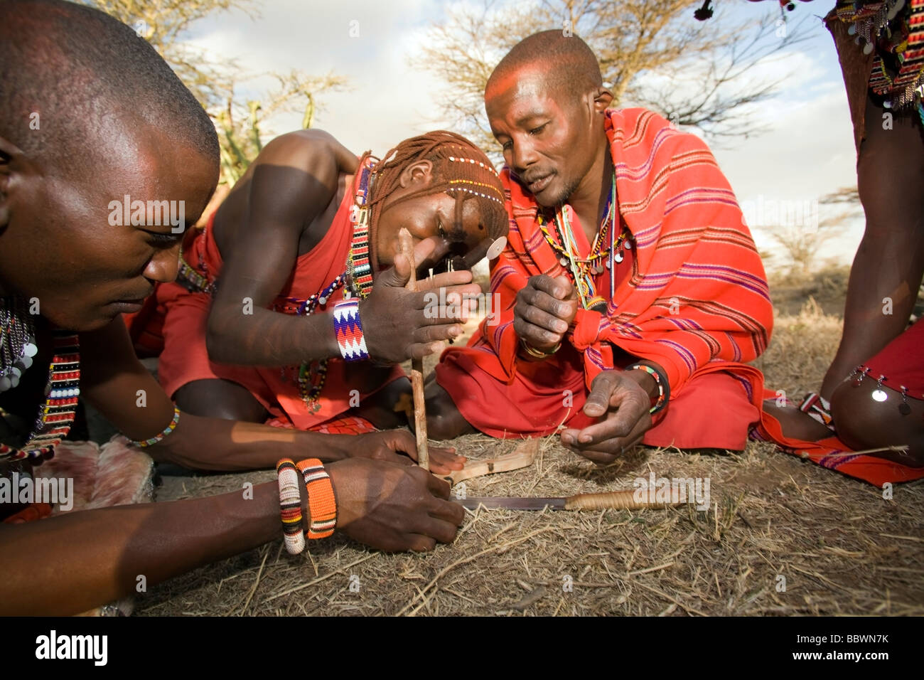Close-up of Maasai warriors making fire - Maji Moto Maasai Village ...