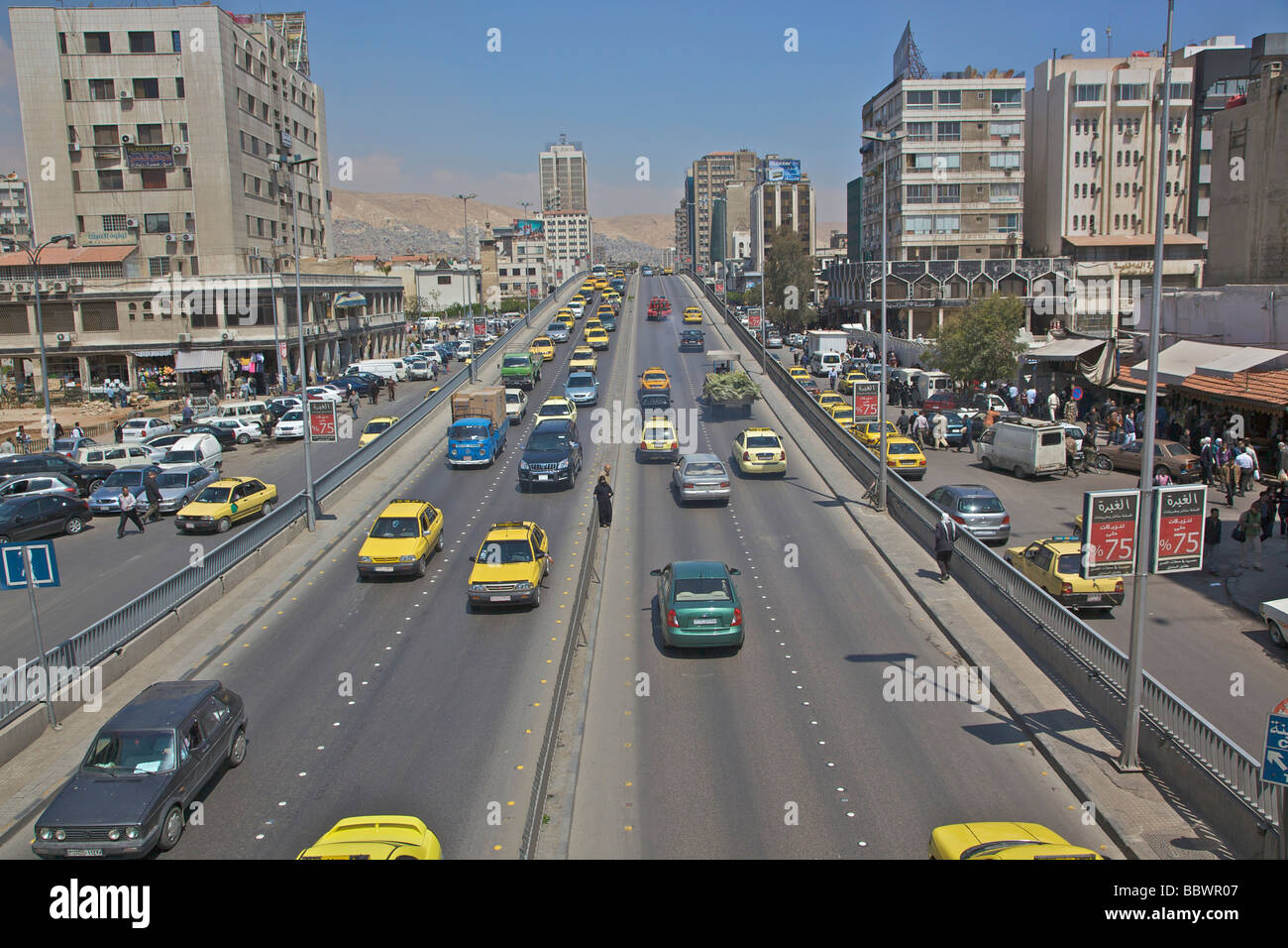 Busy street scene with passing traffic on Ath-Thawra Street, Damascus ...