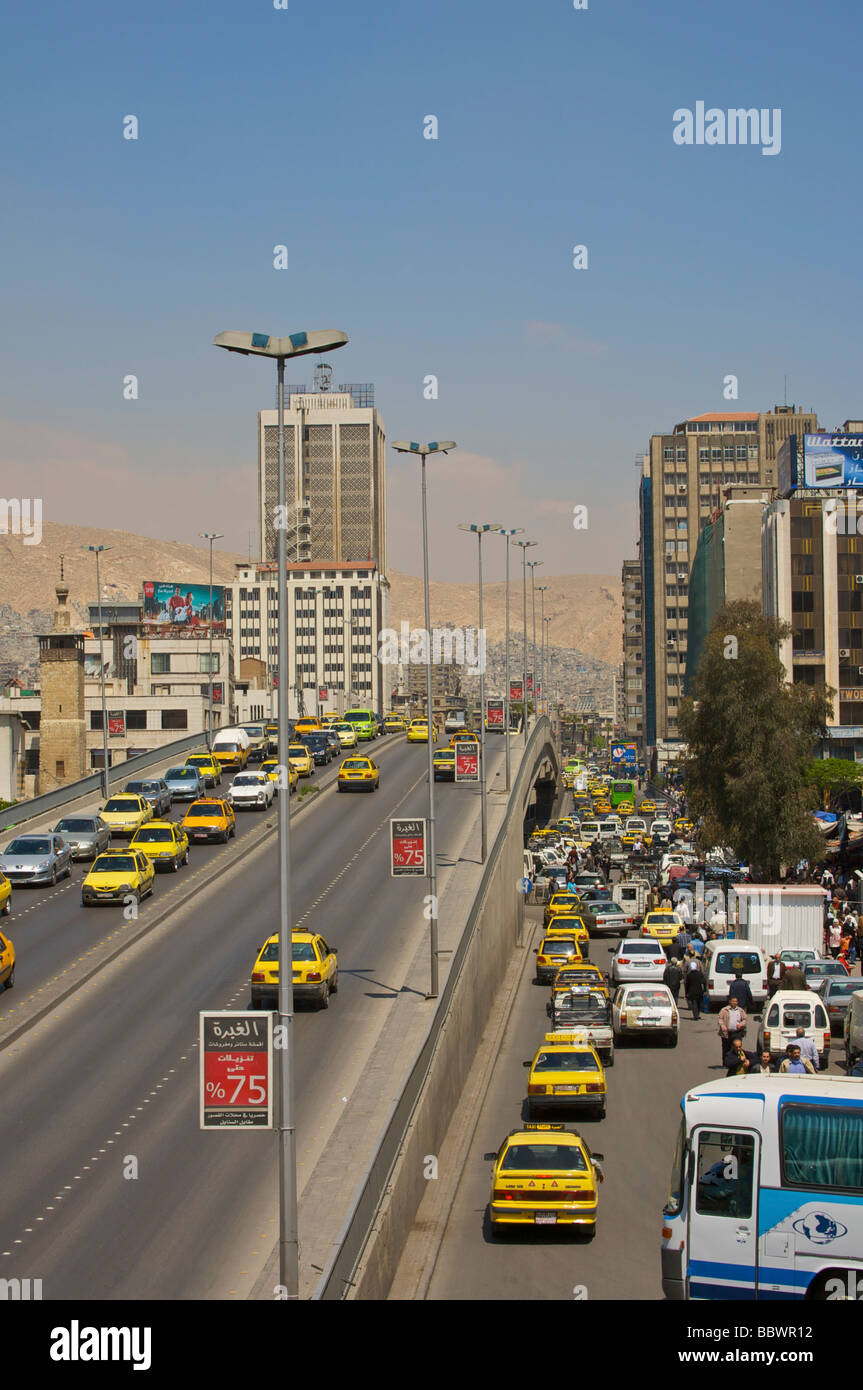 Busy street scene with passing traffic on Ath-Thawra Street, Damascus ...