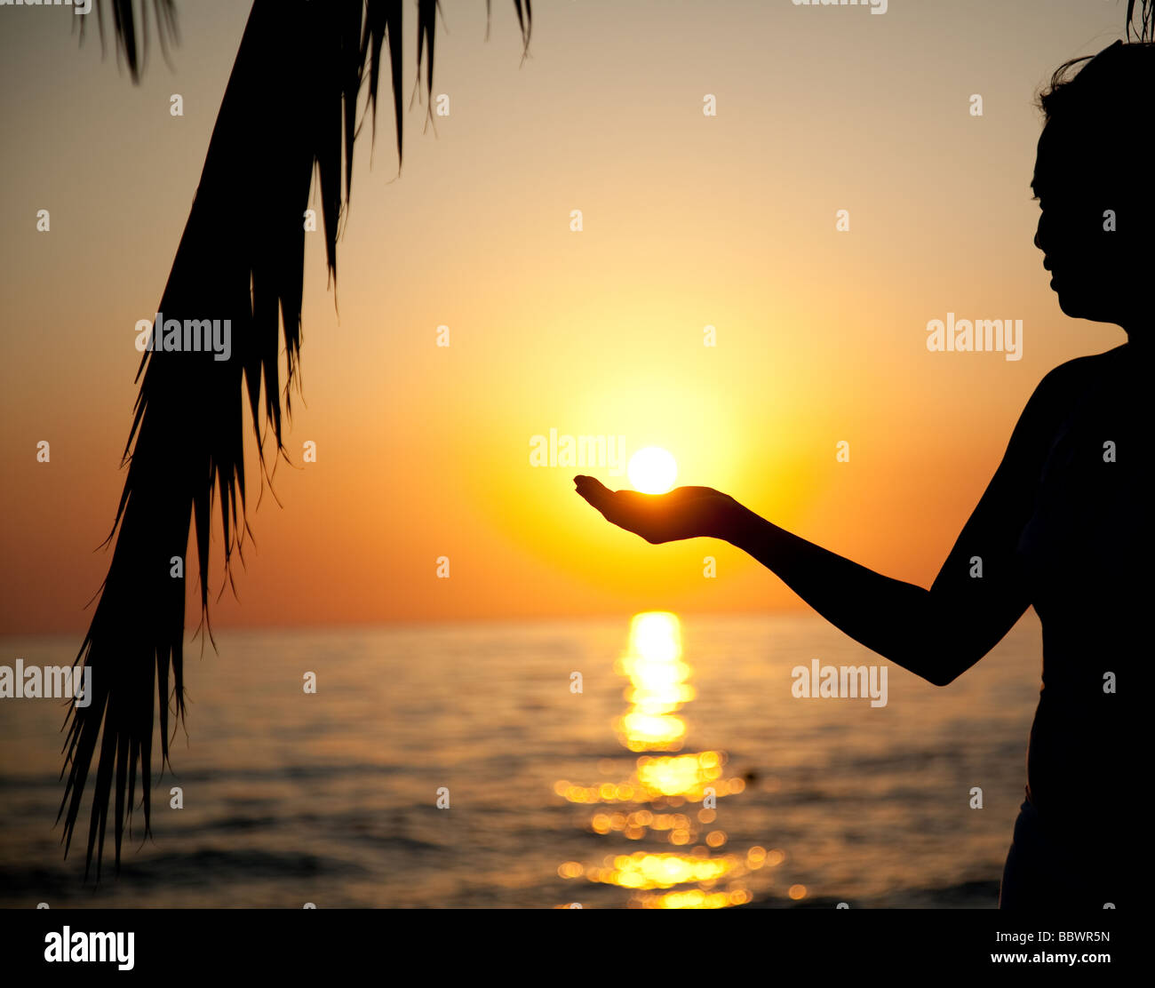 Girl holding the sun Stock Photo - Alamy