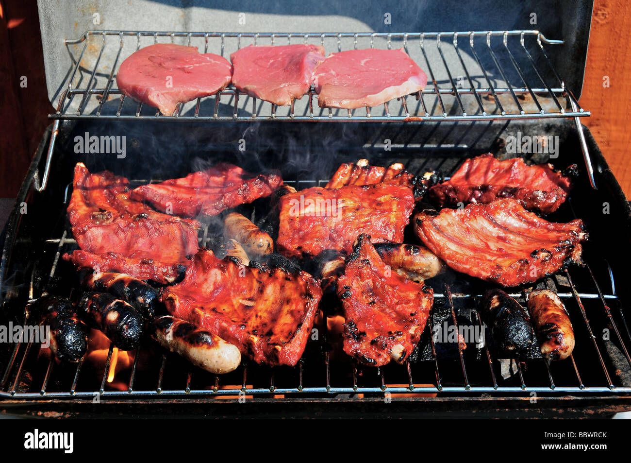 Meat cooking on a barbeque Stock Photo - Alamy
