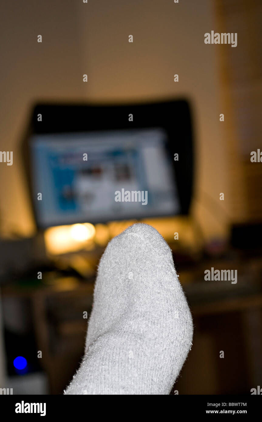 someone relaxing with a computer screen in the background focusing on a ...