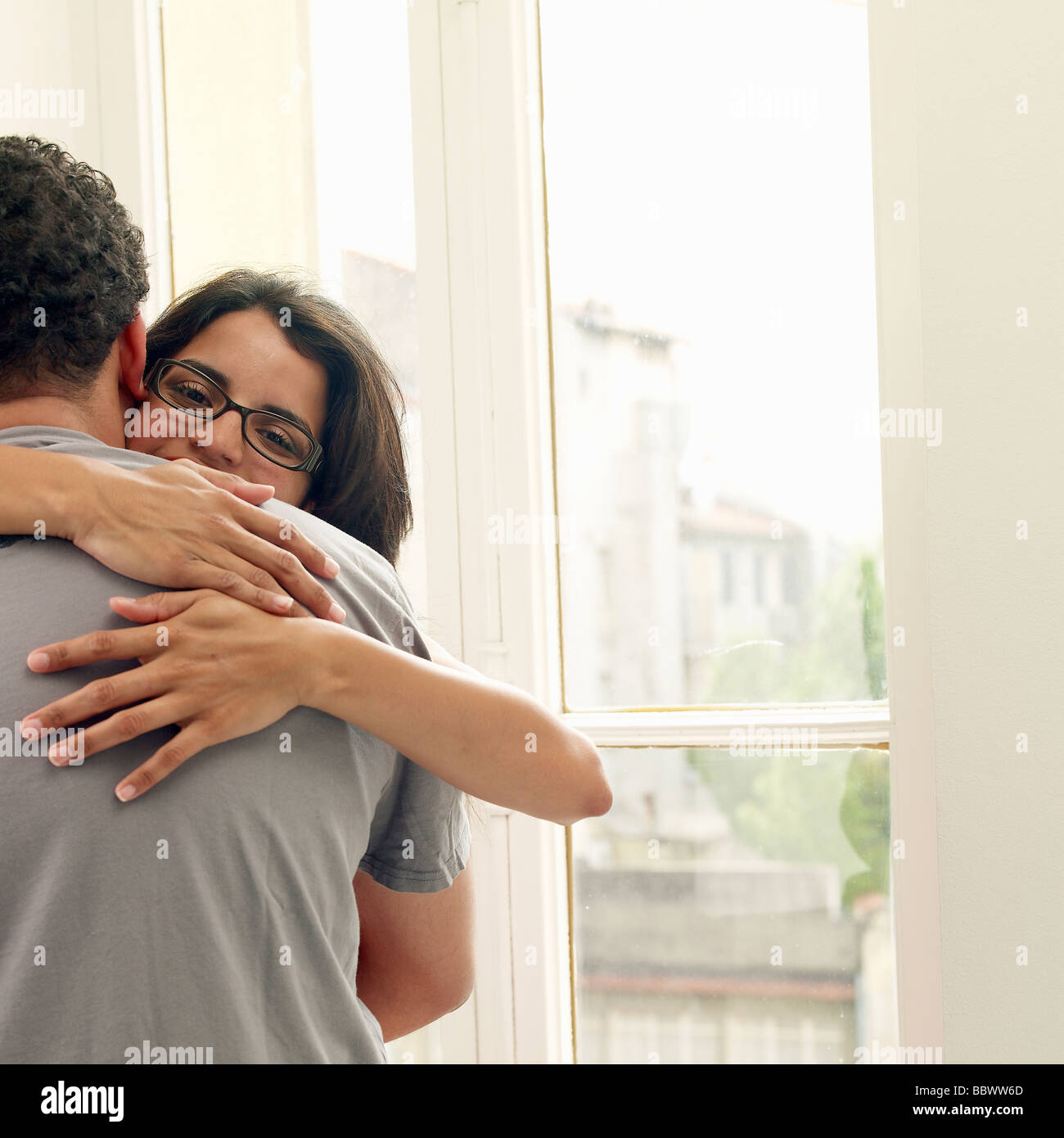 Young people hugging Stock Photo - Alamy