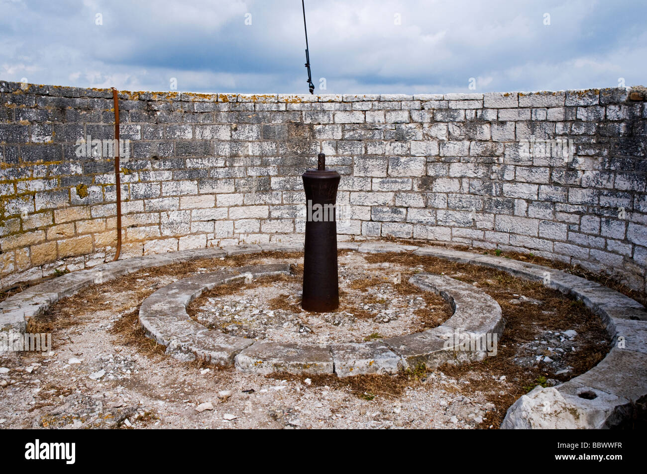 A cannon barrel stands upright as a memorial in a buttress of the ...