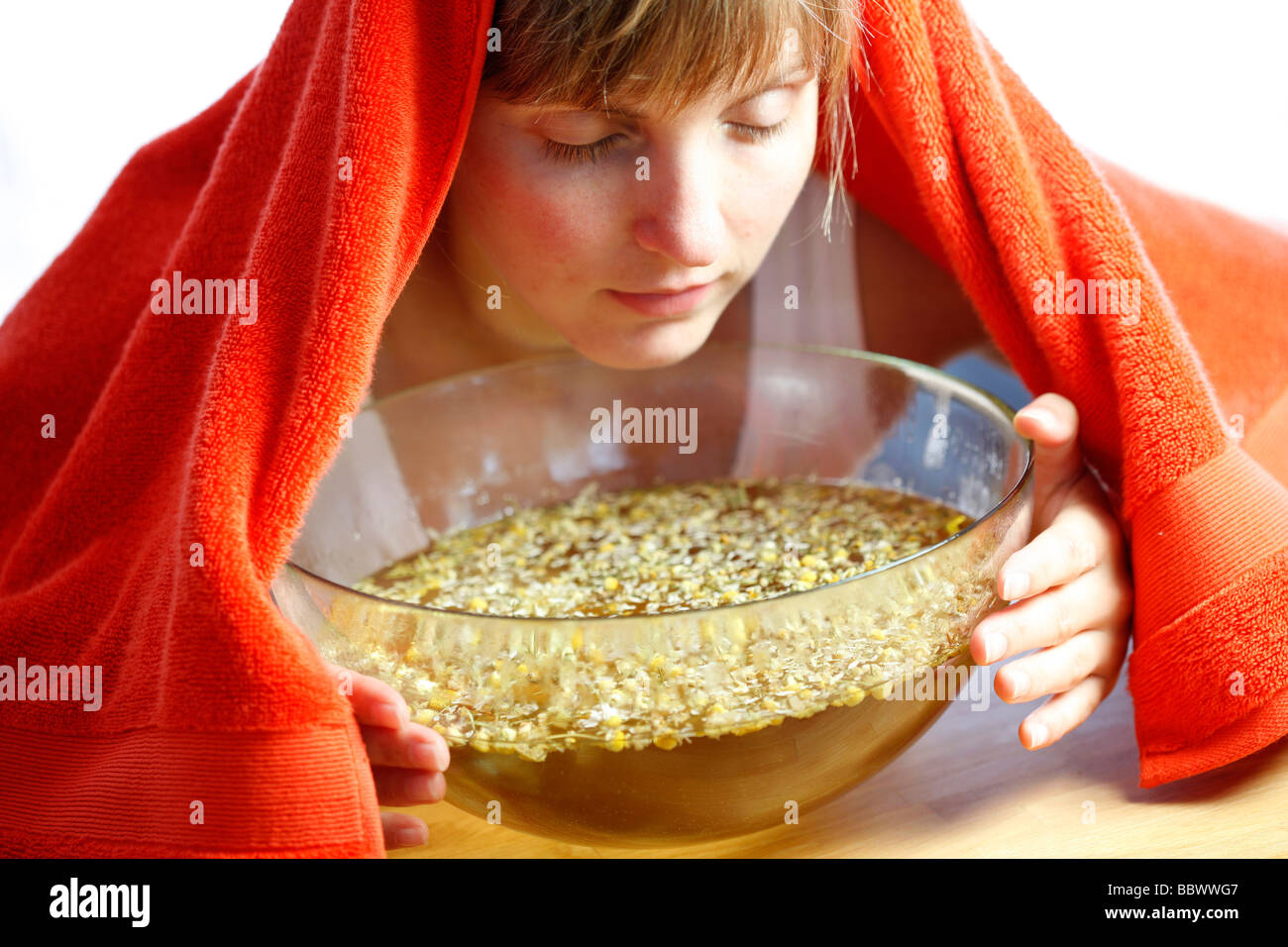 Woman inhaling the fumes of a camomile infusion against a cold Stock ...