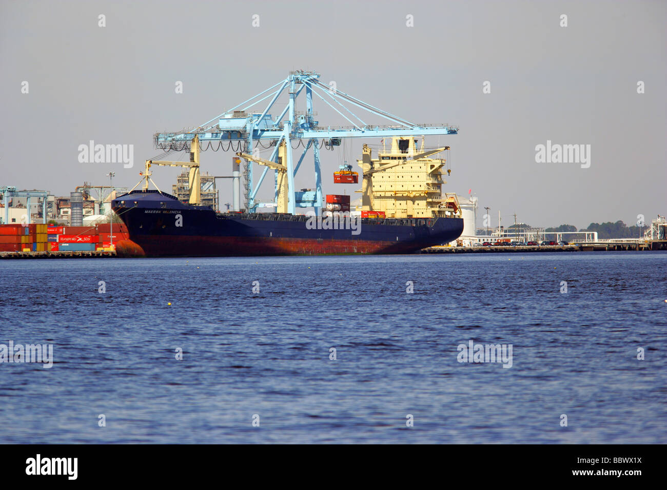 Loading containerships in port Stock Photo - Alamy
