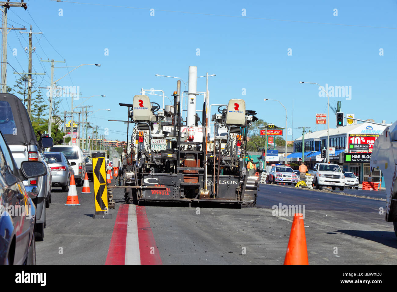 Traffic chaos as roadway is paved during peak hour using machinery and ...