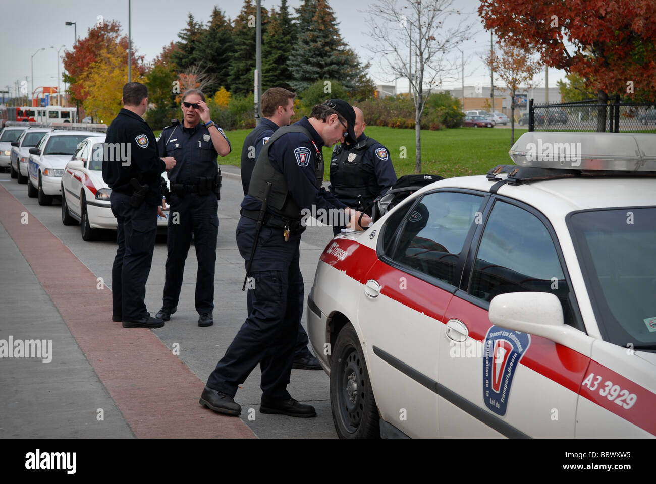 Police officers and security personell discuss an arrest made at ...