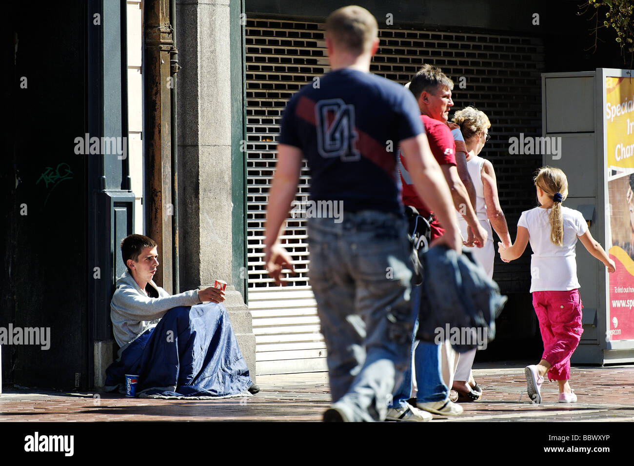 People passing young man begging in the streets of central Dublin ...