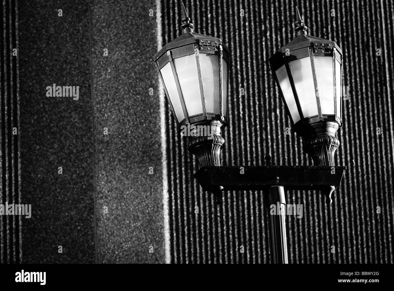Old crooked street lamps infront of stone wall Stock Photo - Alamy