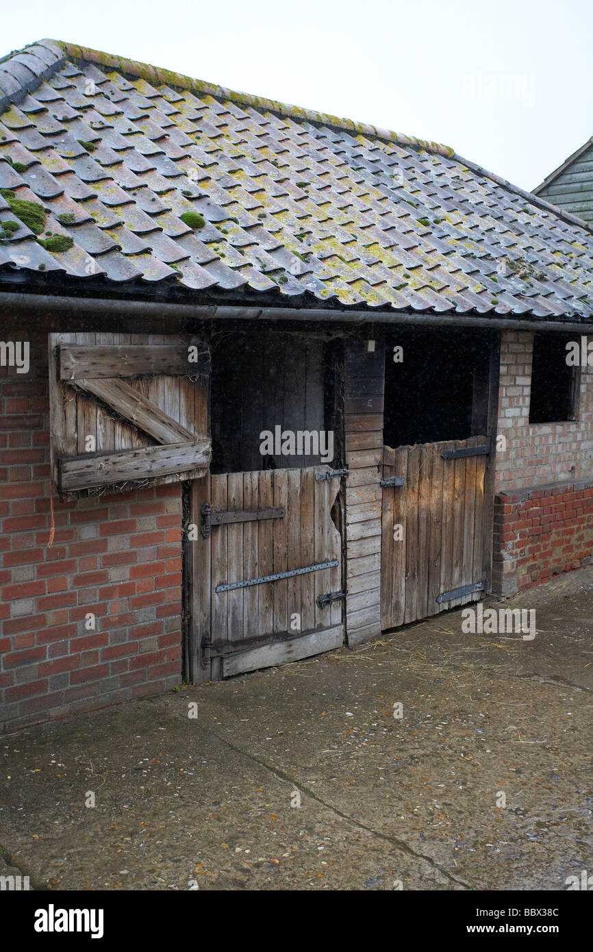 OLD STABLE BLOCK WITH WOODEN DOORS NO HORSES Stock Photo - Alamy