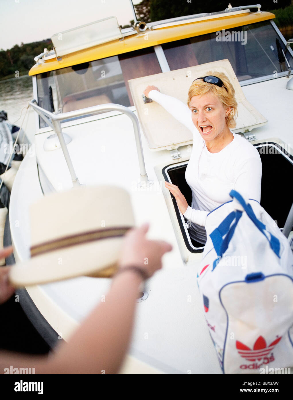 A blond woman screaming on a boat Sweden Stock Photo - Alamy