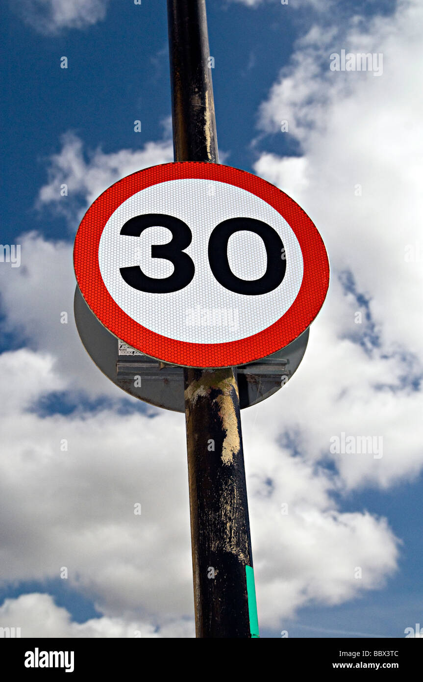 a 30 speed limit sign against a blue sky on a hot day in the uk Stock ...
