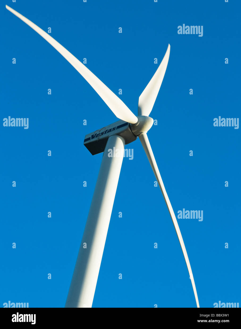Wind turbines spinning against blue hi-res stock photography and images ...