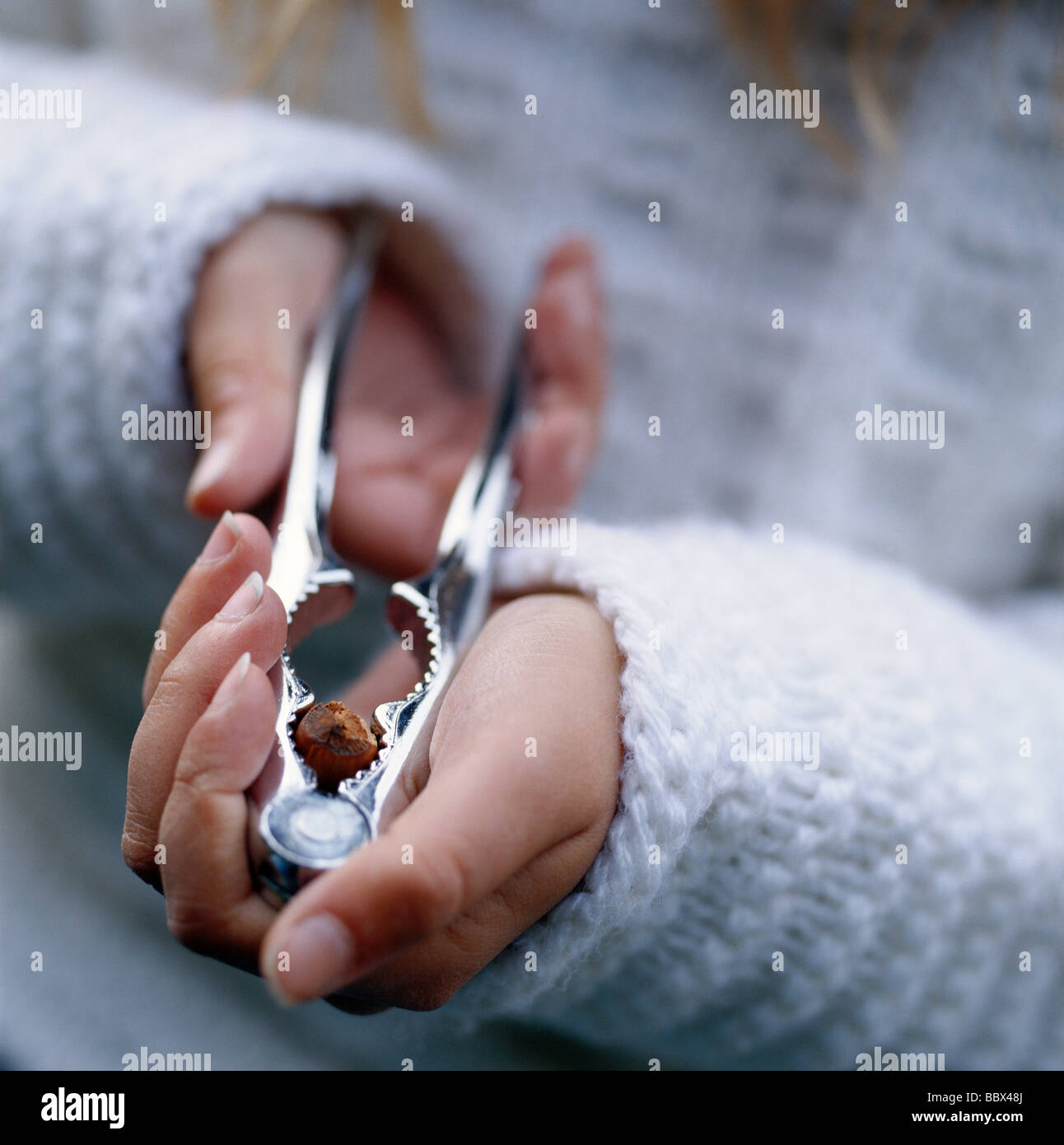 Hand cracking nuts hi-res stock photography and images - Alamy