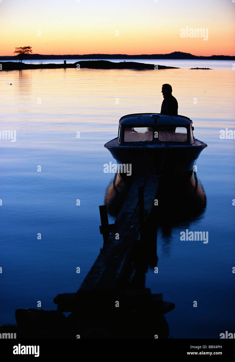 Sunset man boat sweden hi-res stock photography and images - Alamy