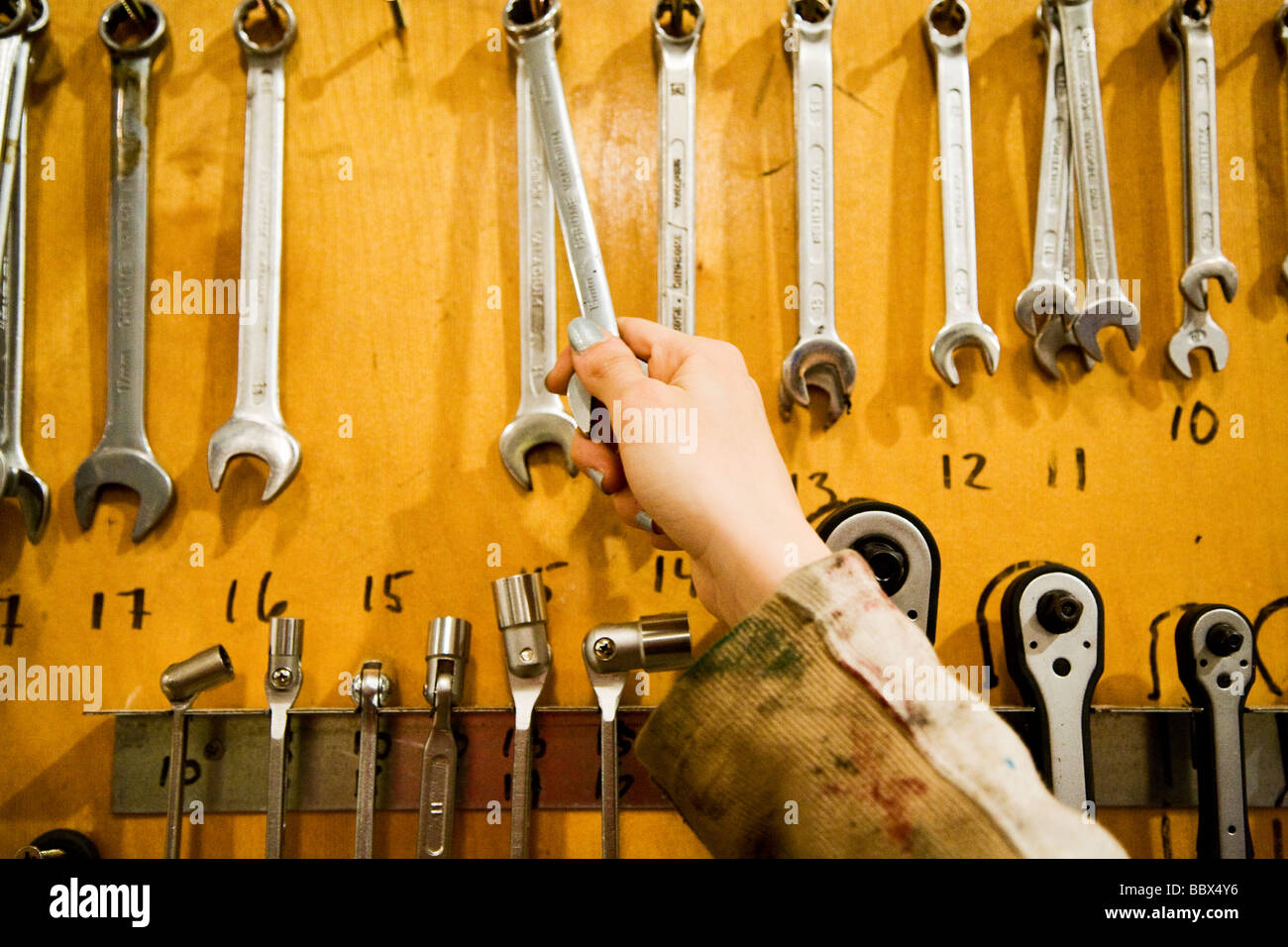A girl reaching for a tool Sweden Stock Photo - Alamy