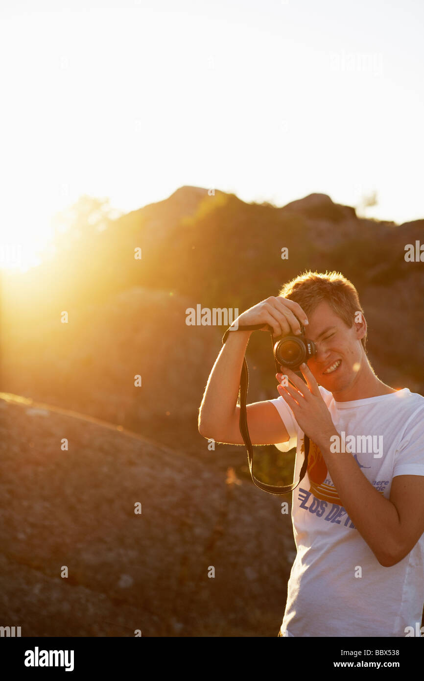A young man taking a picture in the sun Sweden Stock Photo - Alamy