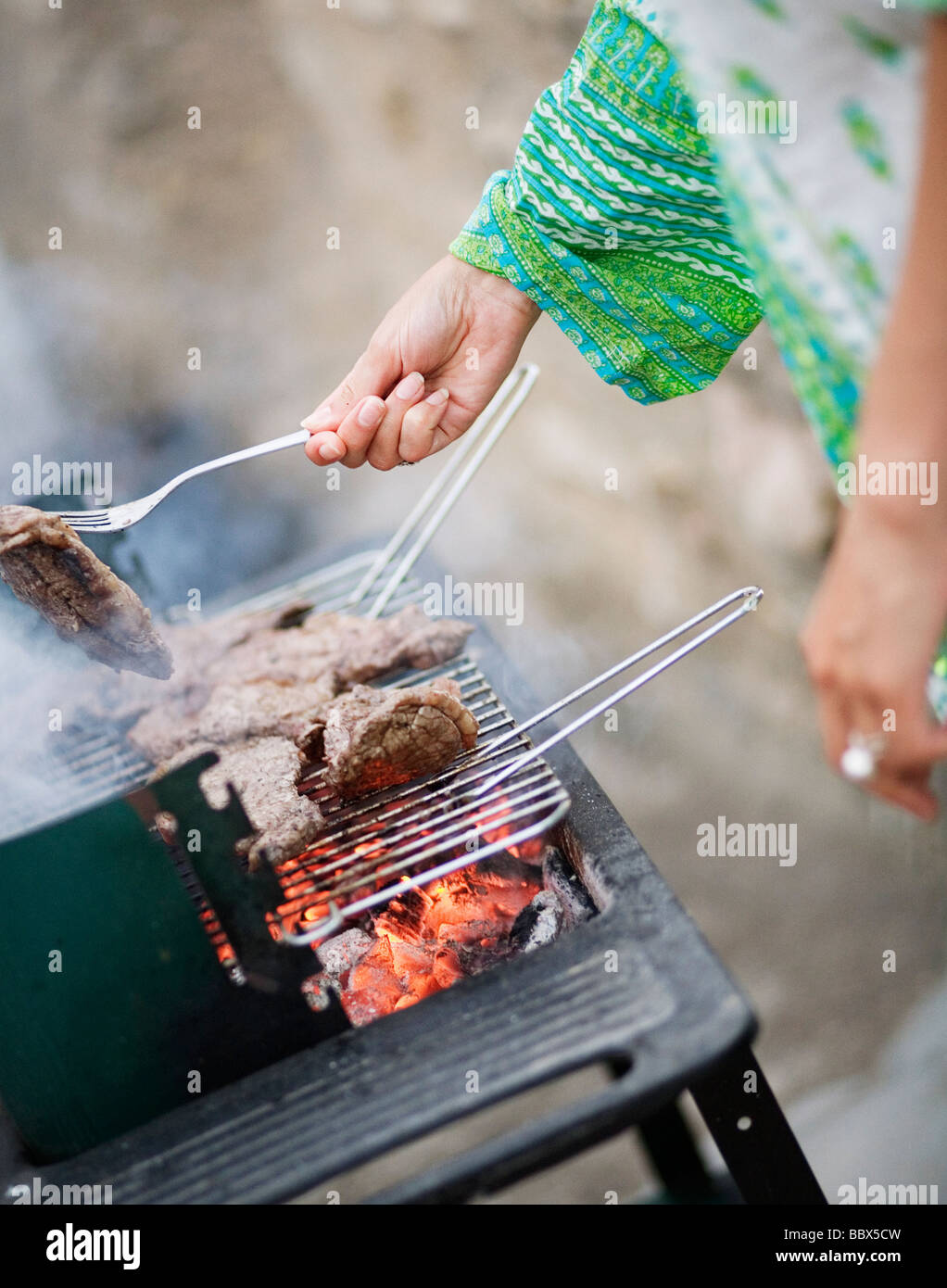 A woman barbecuing Spain Stock Photo - Alamy