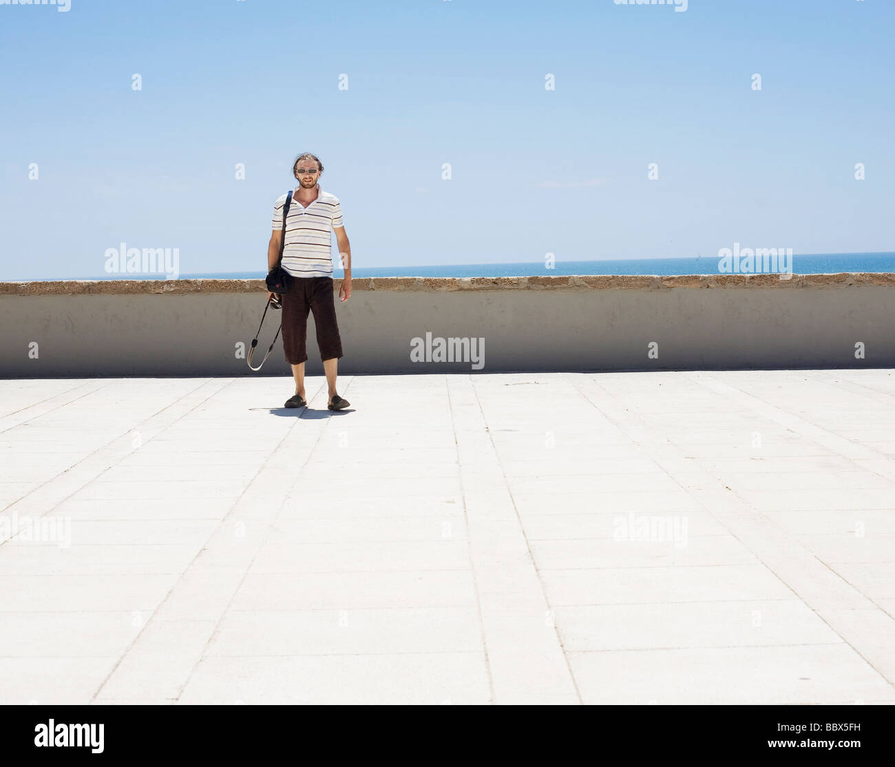 A man standing on a pavement Spain Stock Photo - Alamy