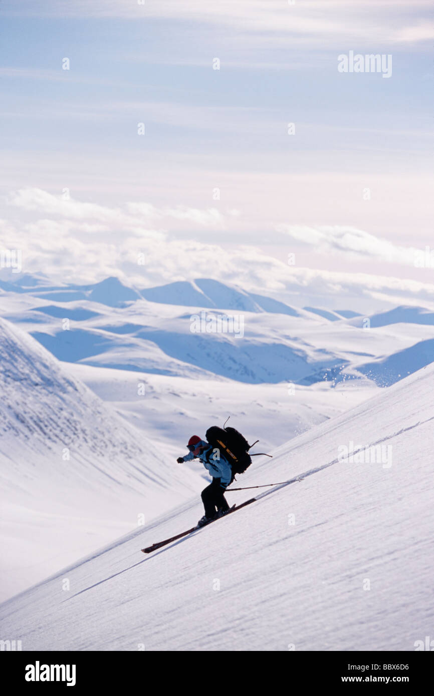 Person skiing down slope side view Stock Photo - Alamy