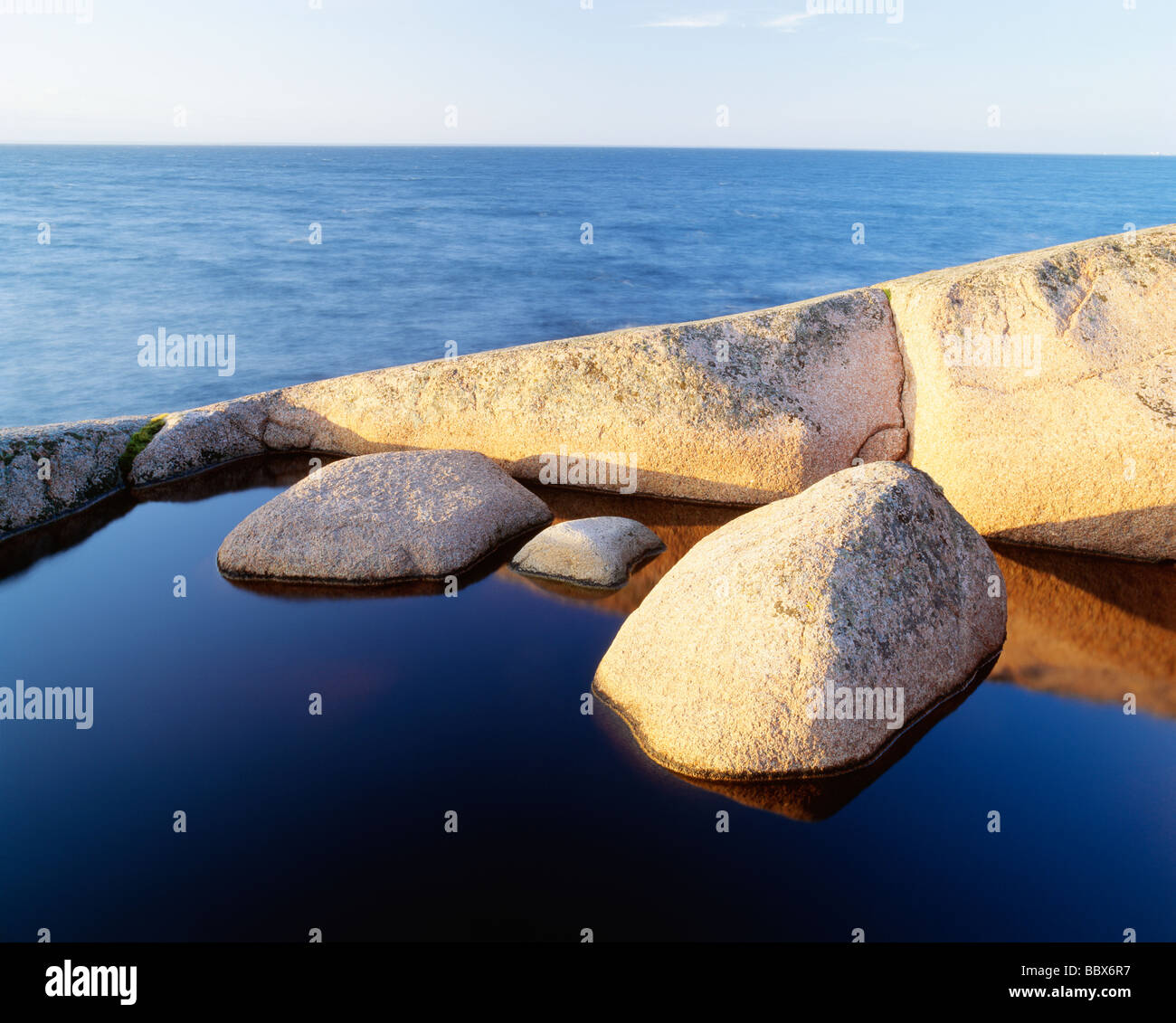 Boulders by sea Stock Photo - Alamy